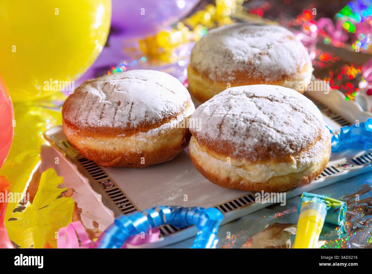 Carnival doughnuts on a rectangular plate with carnival decorations ...