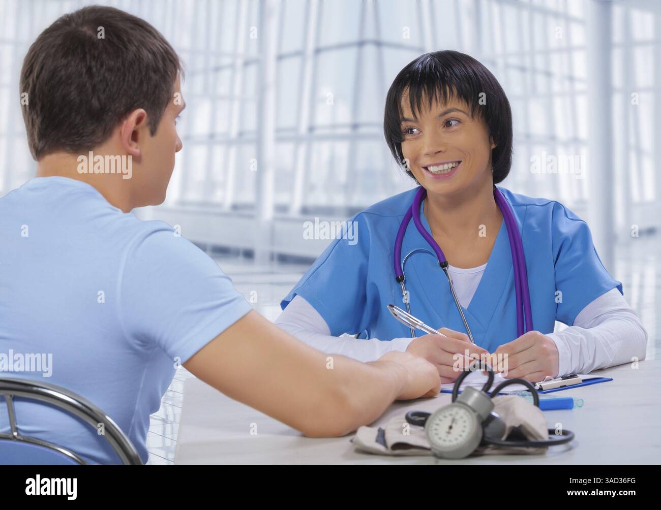 Asian female doctor speaking with patient Stock Photo - Alamy