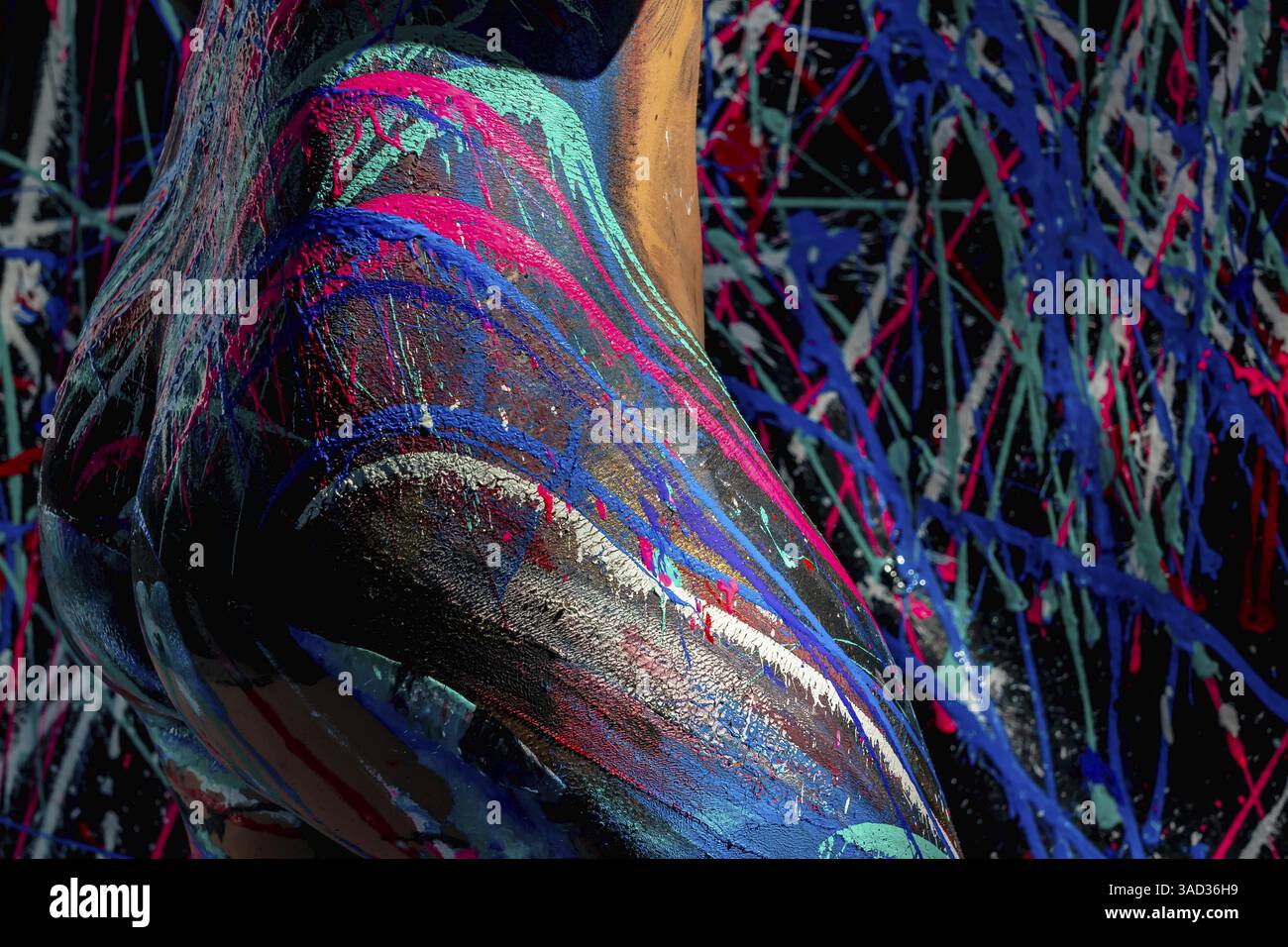 A model poses gracefully, her body adorned in vibrant body paint, with ...