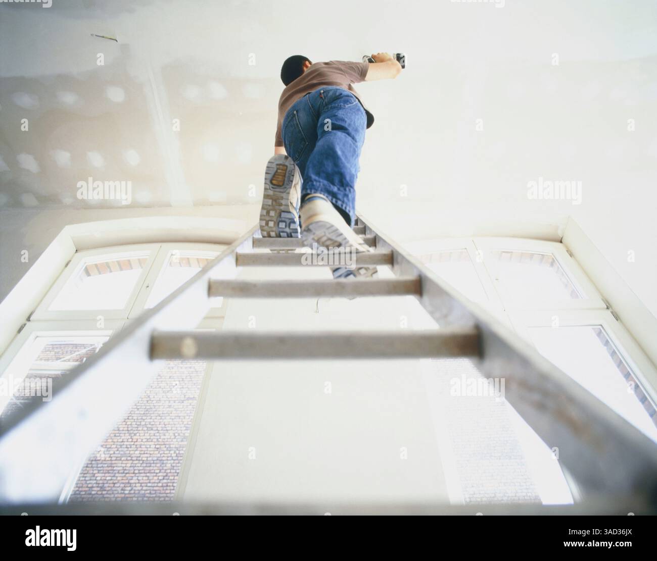 Man standing on ladder hole hi-res stock photography and images - Alamy