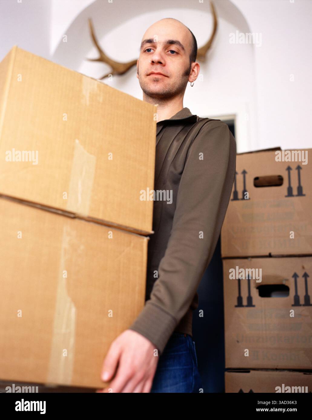 Young Man Carrying Cardboard Boxes Stock Photo - Alamy