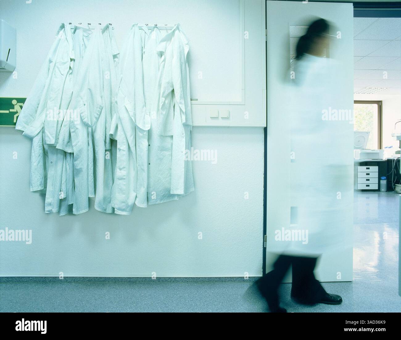 Woman Walking Past Overalls Stock Photo - Alamy