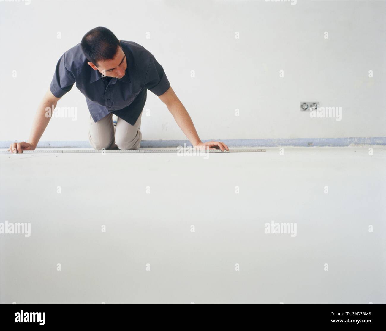 Man measuring floor in room Stock Photo - Alamy