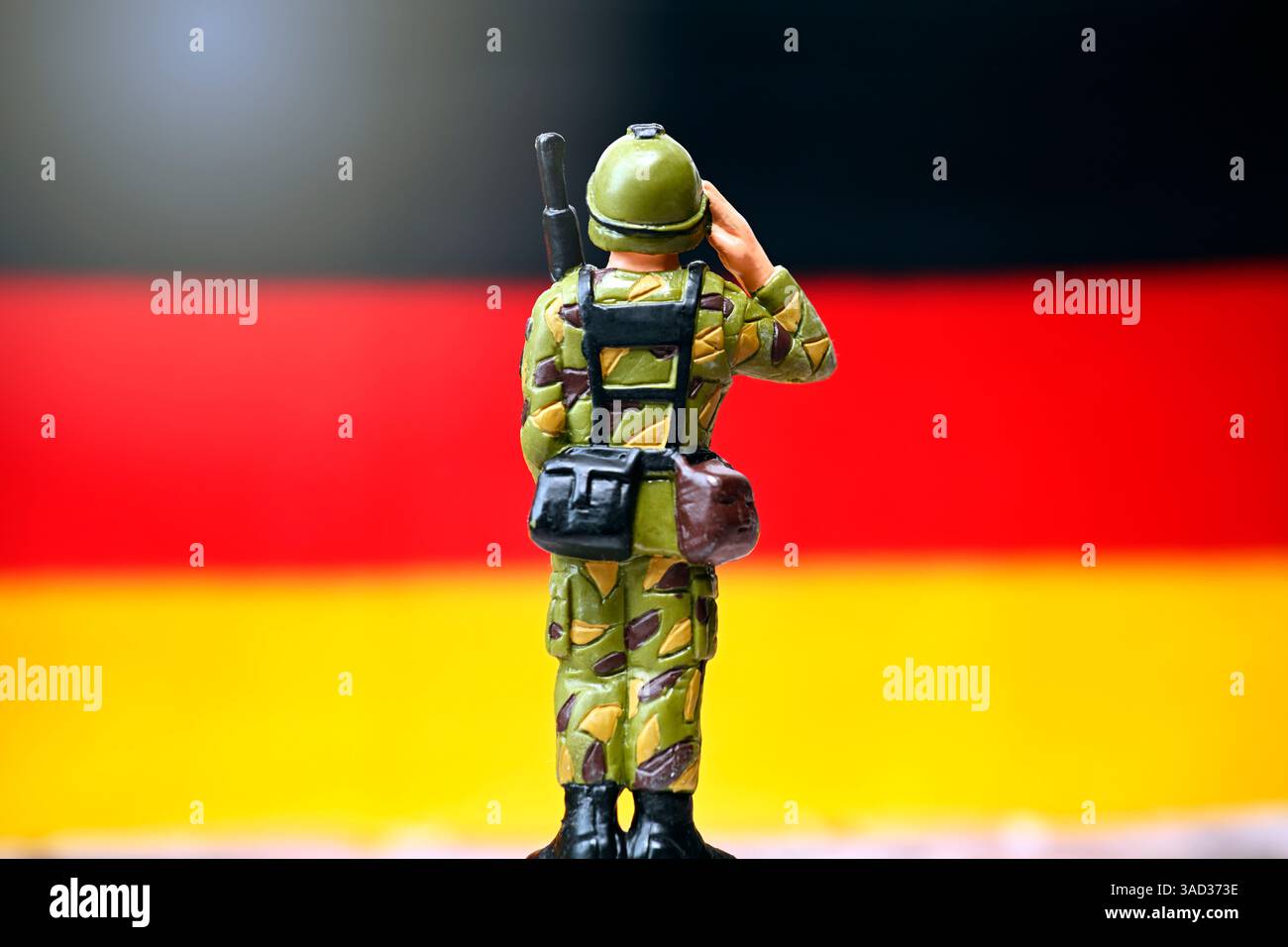 Soldier in front of a German flag, symbolic photo of compulsory ...