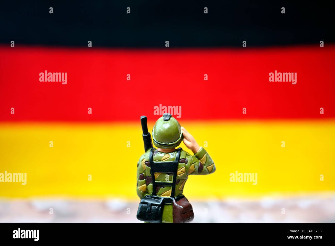Soldier in front of a German flag, symbolic photo of compulsory ...
