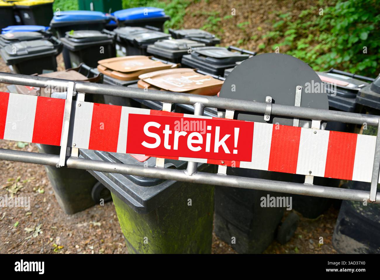 Barrier beacon with inscription strike in front of garbage cans, strike ...