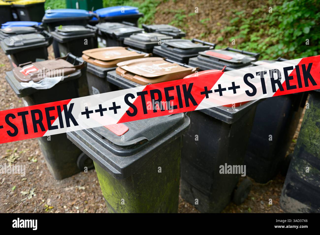 Barrier tape with the words strike in front of garbage cans, strike ...