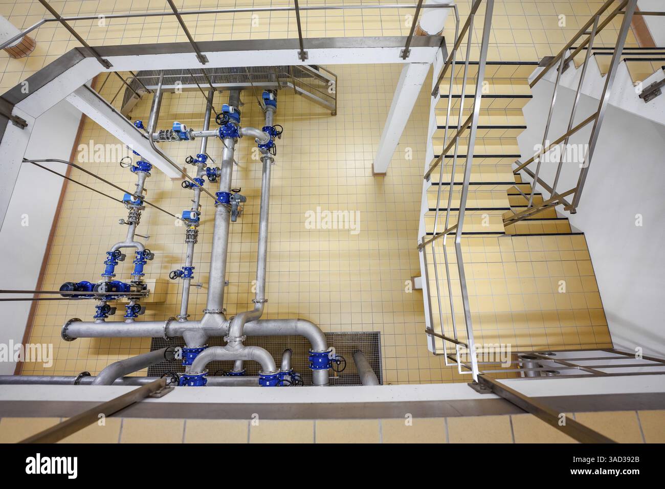 Industrial interior staircase with surrounding stainless steel pipes, ENCW Netze Calw waterworks ...
