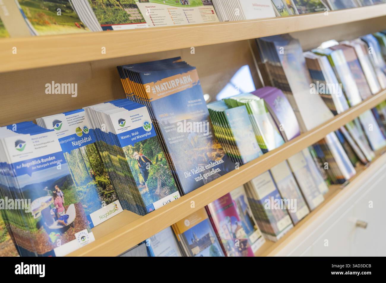 Shelves full of colourful brochures and leaflets about nature and ...