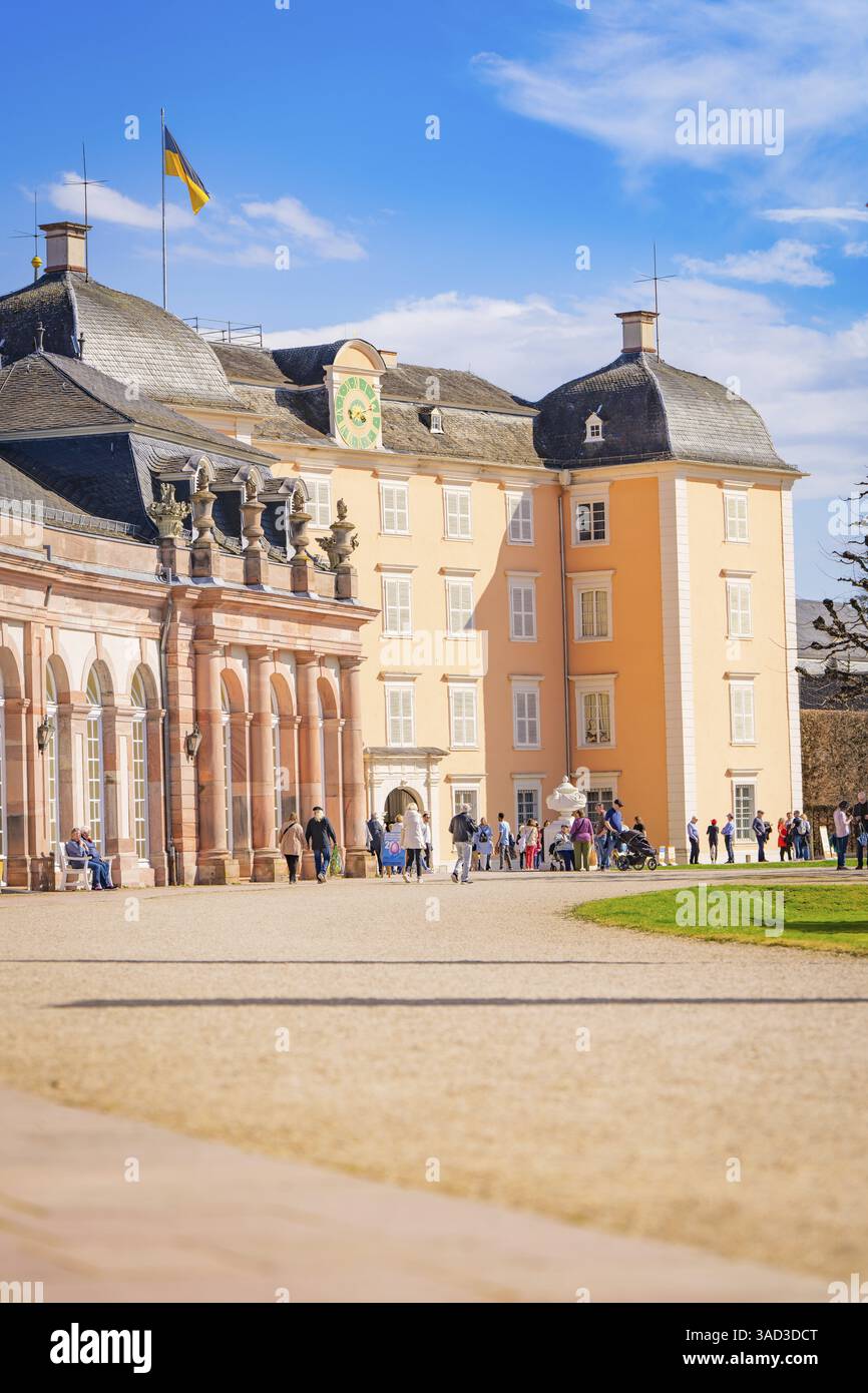 People in front of an elegant castle with a flag. Lively atmosphere in ...