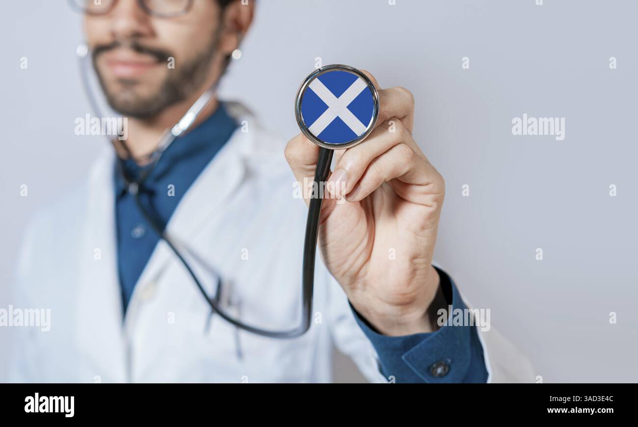 Doctor holding stethoscope with Scotland flag. Scotland health and care ...