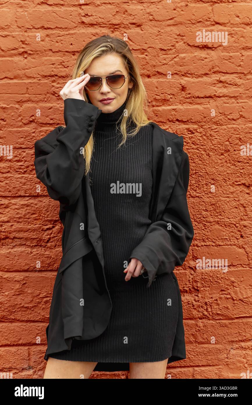 A gorgeous blonde woman strolls through a quaint small town, wrapped in ...