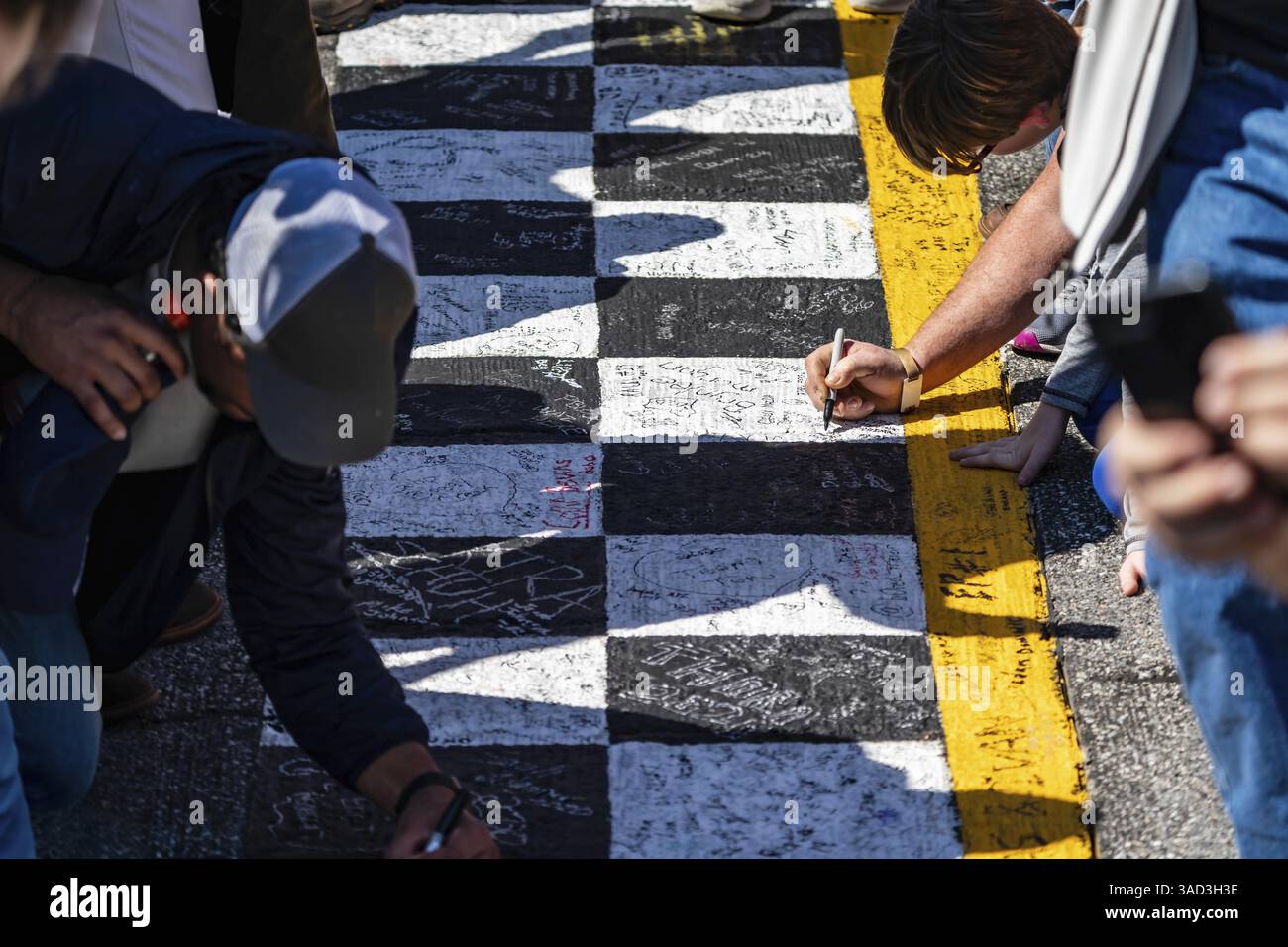 Before every big racing event, fans sign the start/finish line, leaving ...