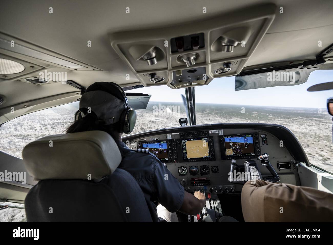 Cockpit Cesna Caravan with pilot on approach to Airstrip, Okawango ...