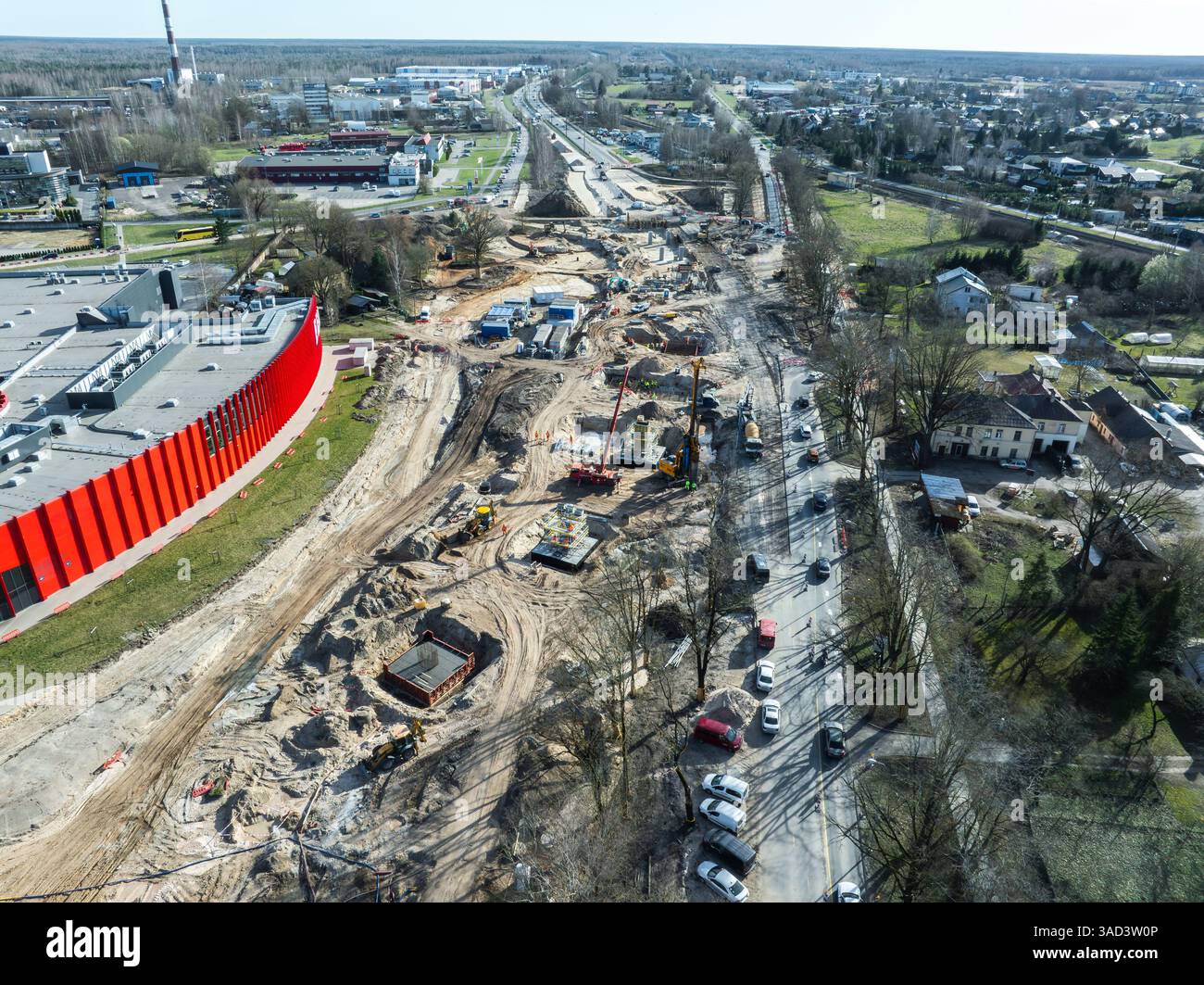 Construction Site in Riga with Red Curved Building and Busy Road Stock ...