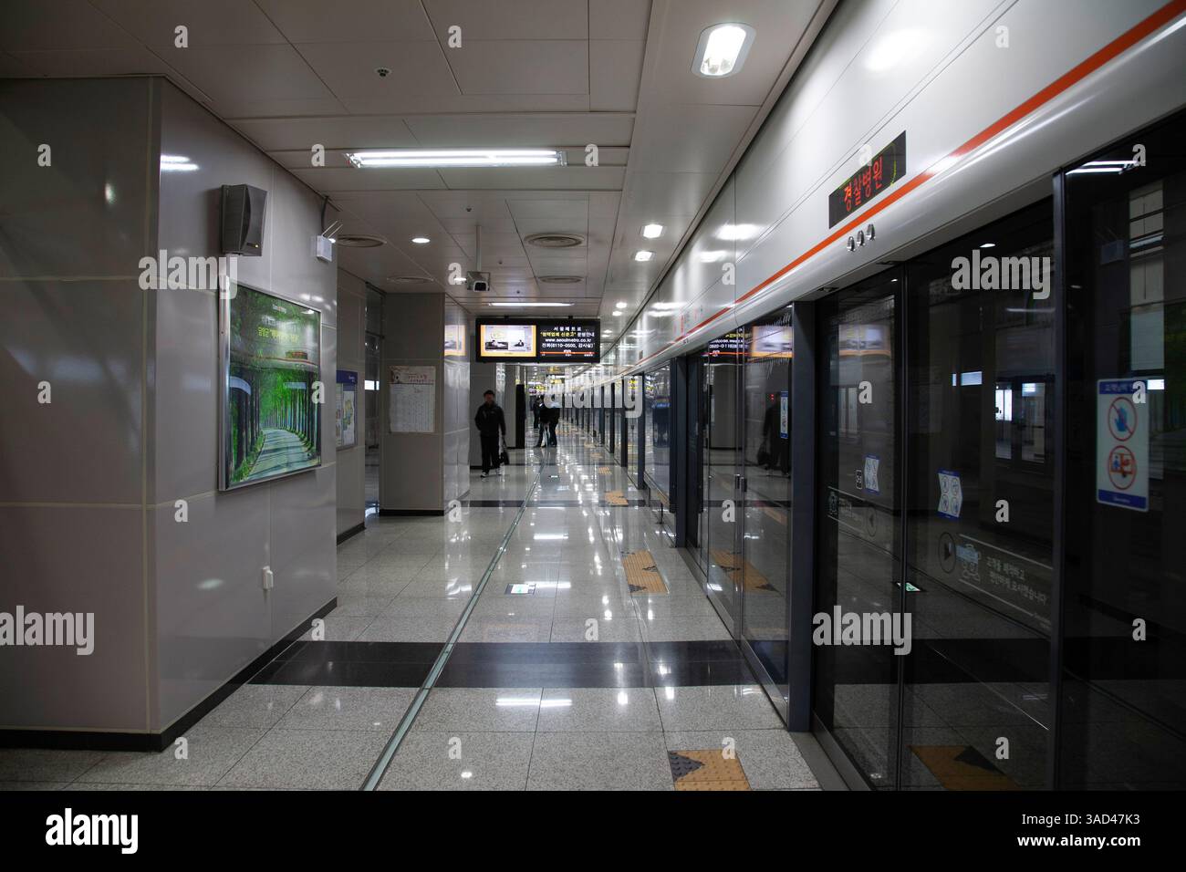 SEOUL, SOUTH KOREA. 22 APRIL, 2011. Passengers wait near closed screen ...