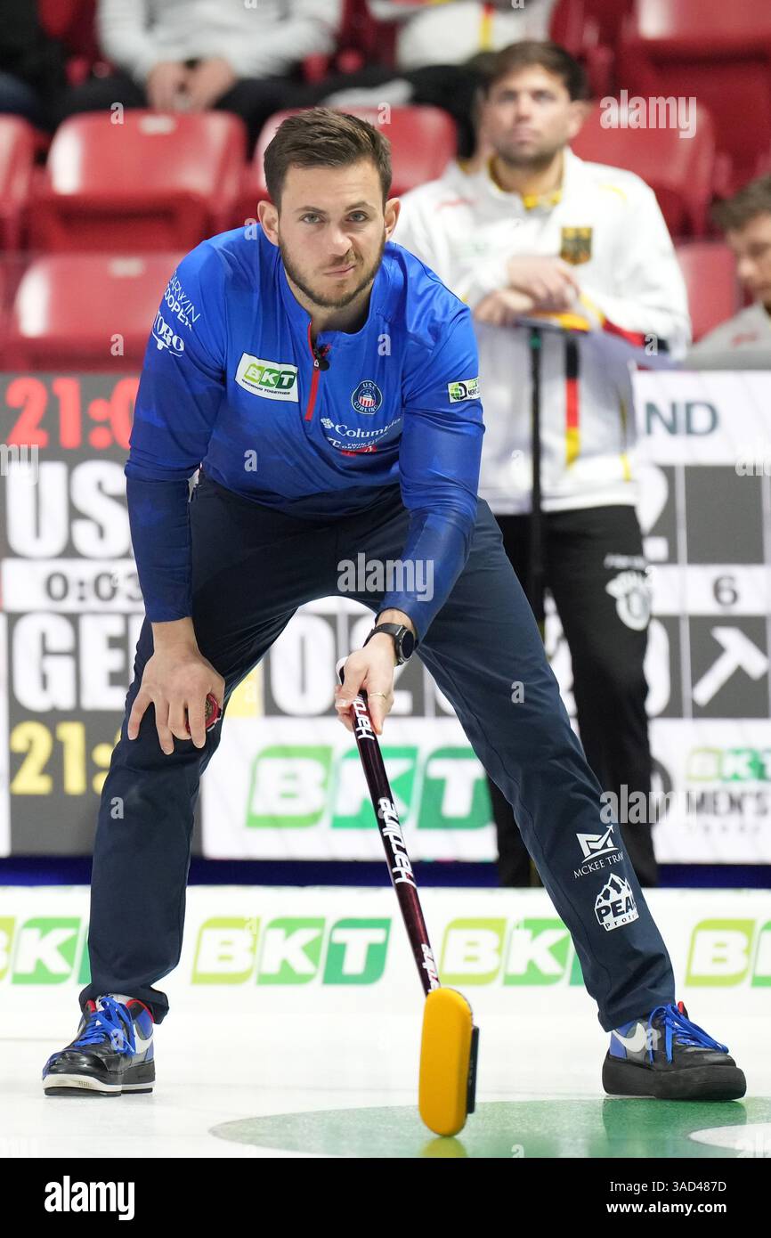 USA skip Korey Dropkin lines up a stone as Germany's skip Marc ...