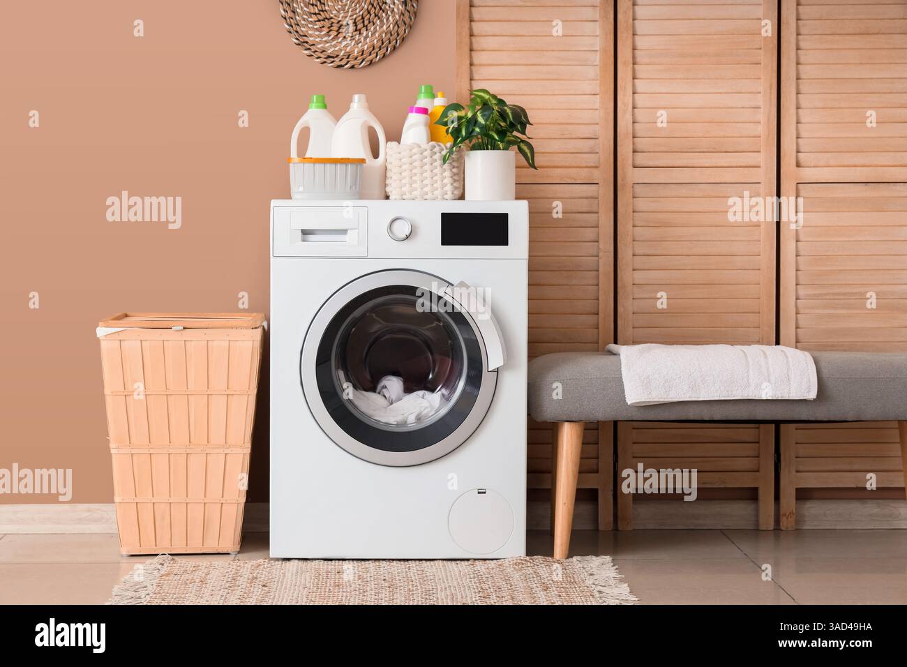 Modern washing machine with laundry, folding screen, bench and basket ...