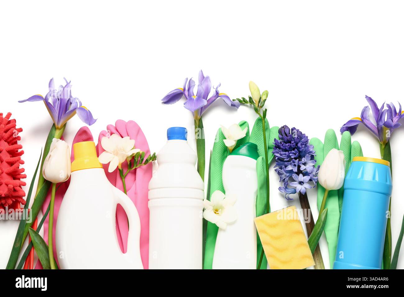 Bottles of detergents with cleaning tools and spring flowers on white ...