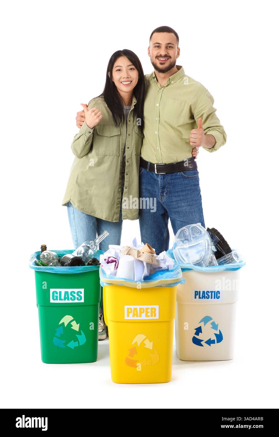 Young couple with sorted rubbish in garbage bins showing thumbs-up on ...