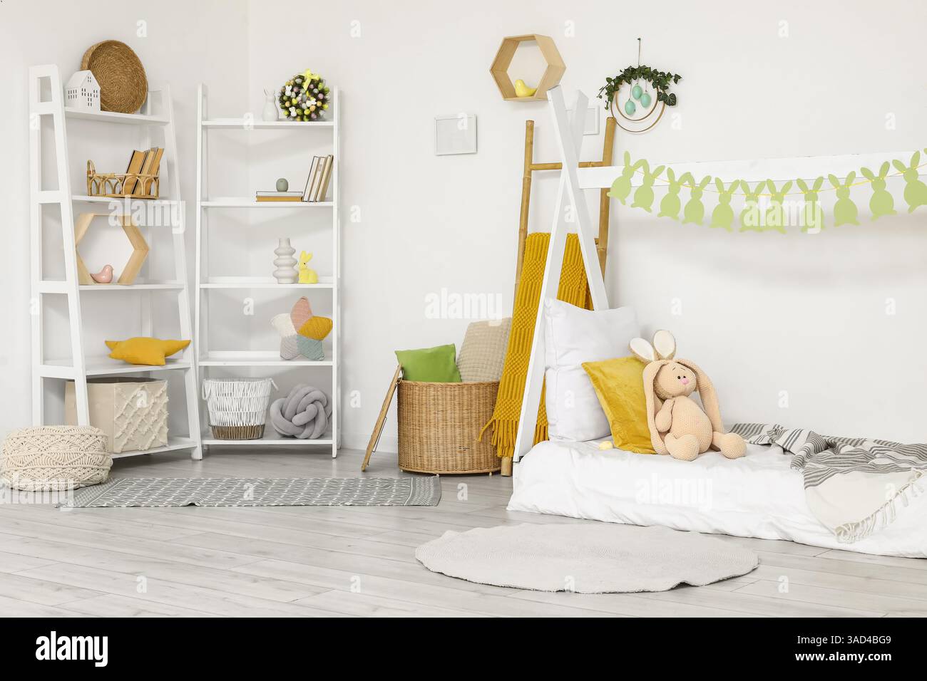 Interior of children's room decorated for Easter with bed and shelf ...