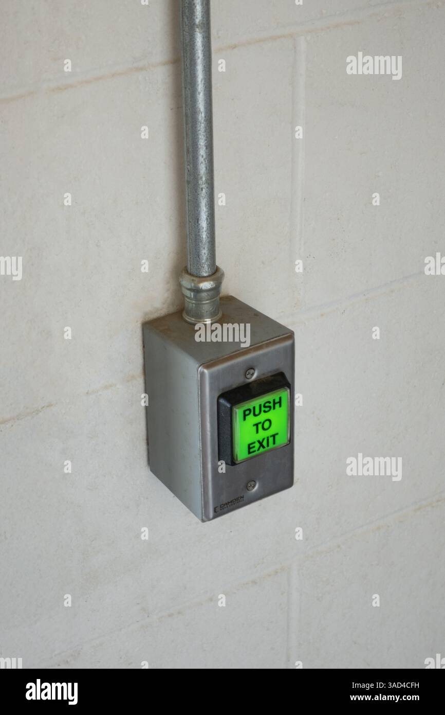 Illuminated green push to exit button on wall Stock Photo - Alamy
