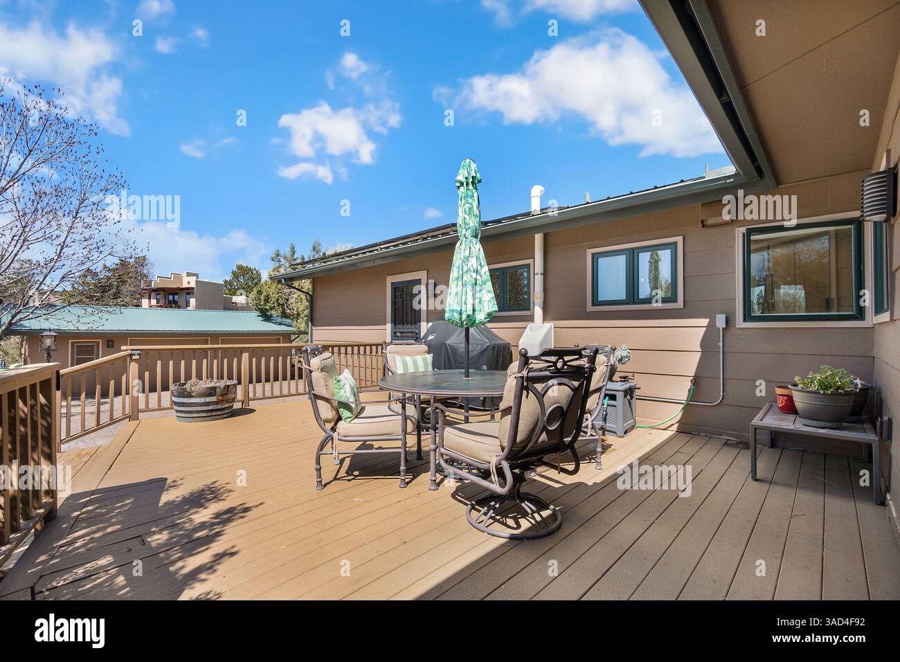A large brick patio in front of a house with porch and stairs Stock ...