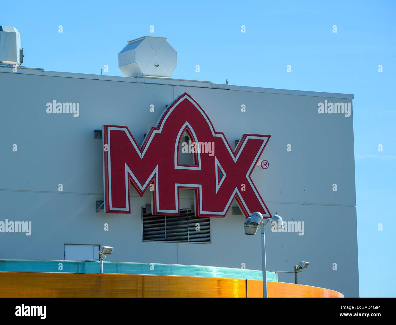 Brightly lit structure showcases a bold red MAX sign against a clear ...