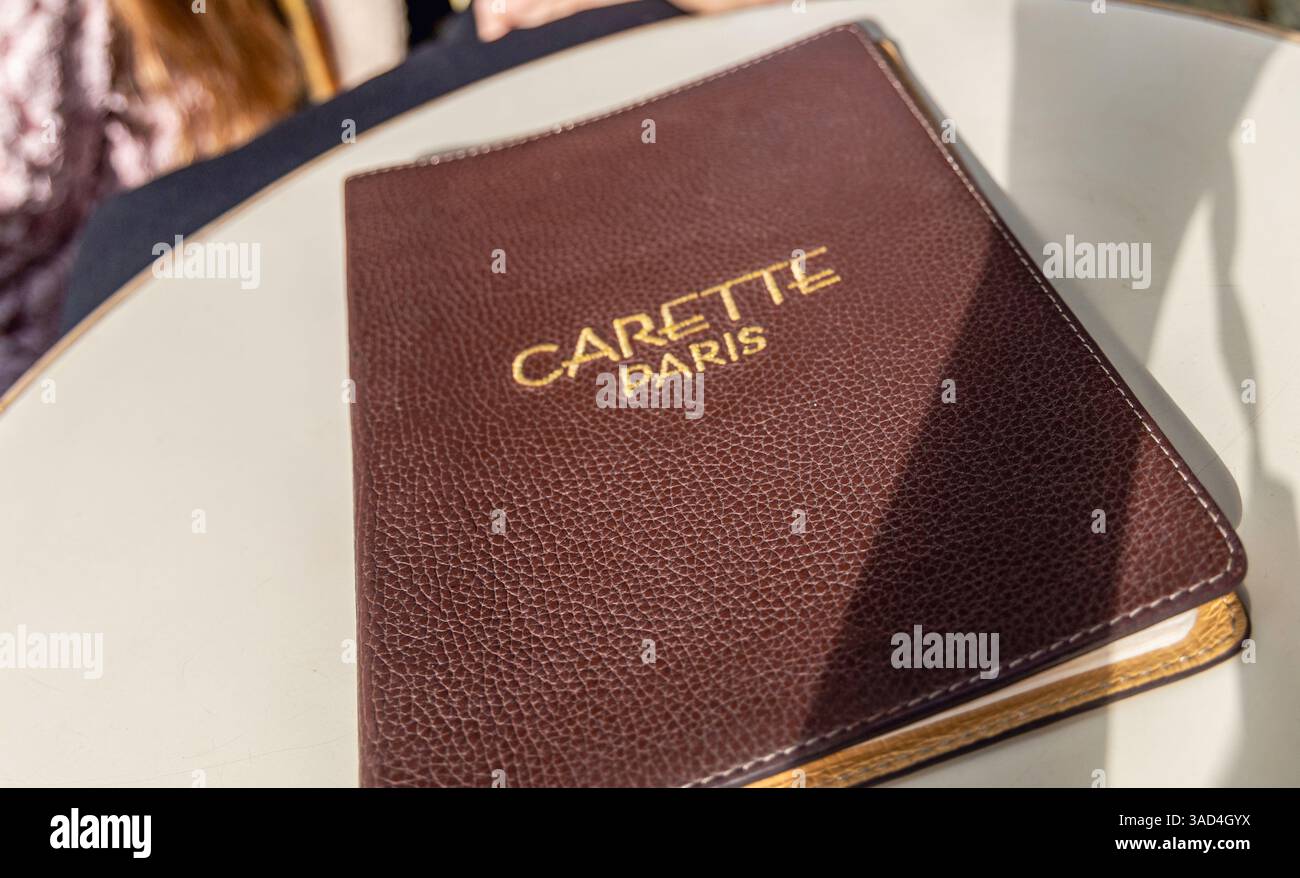 Table with white tablecloth and food menu in restaurant Carette in ...