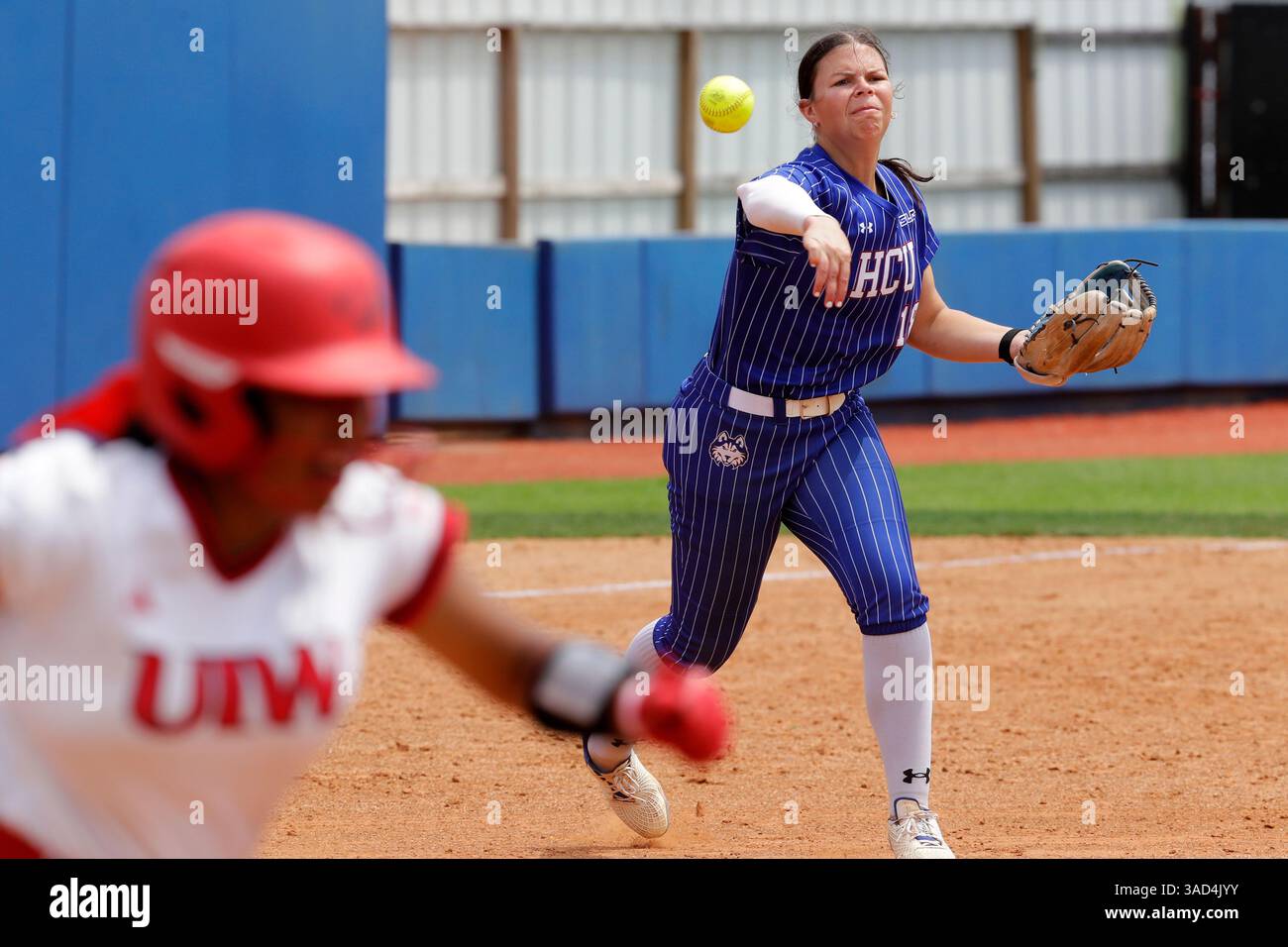Houston Christian third baseman Haylie Savage, right, makes the play to ...