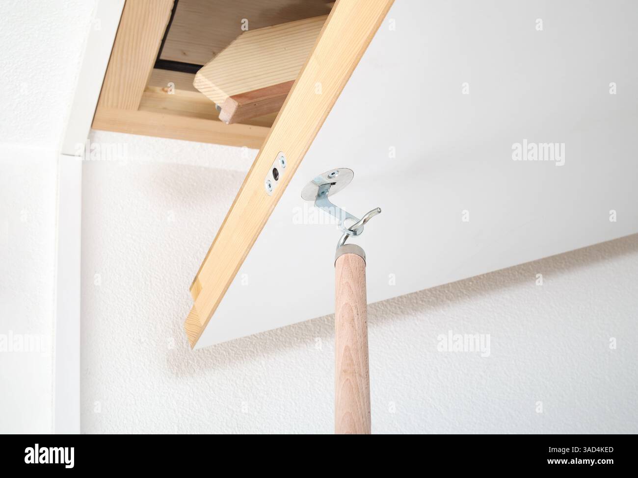 Attic hatch or loft door is opened with handle. Loft sliding ladder ...