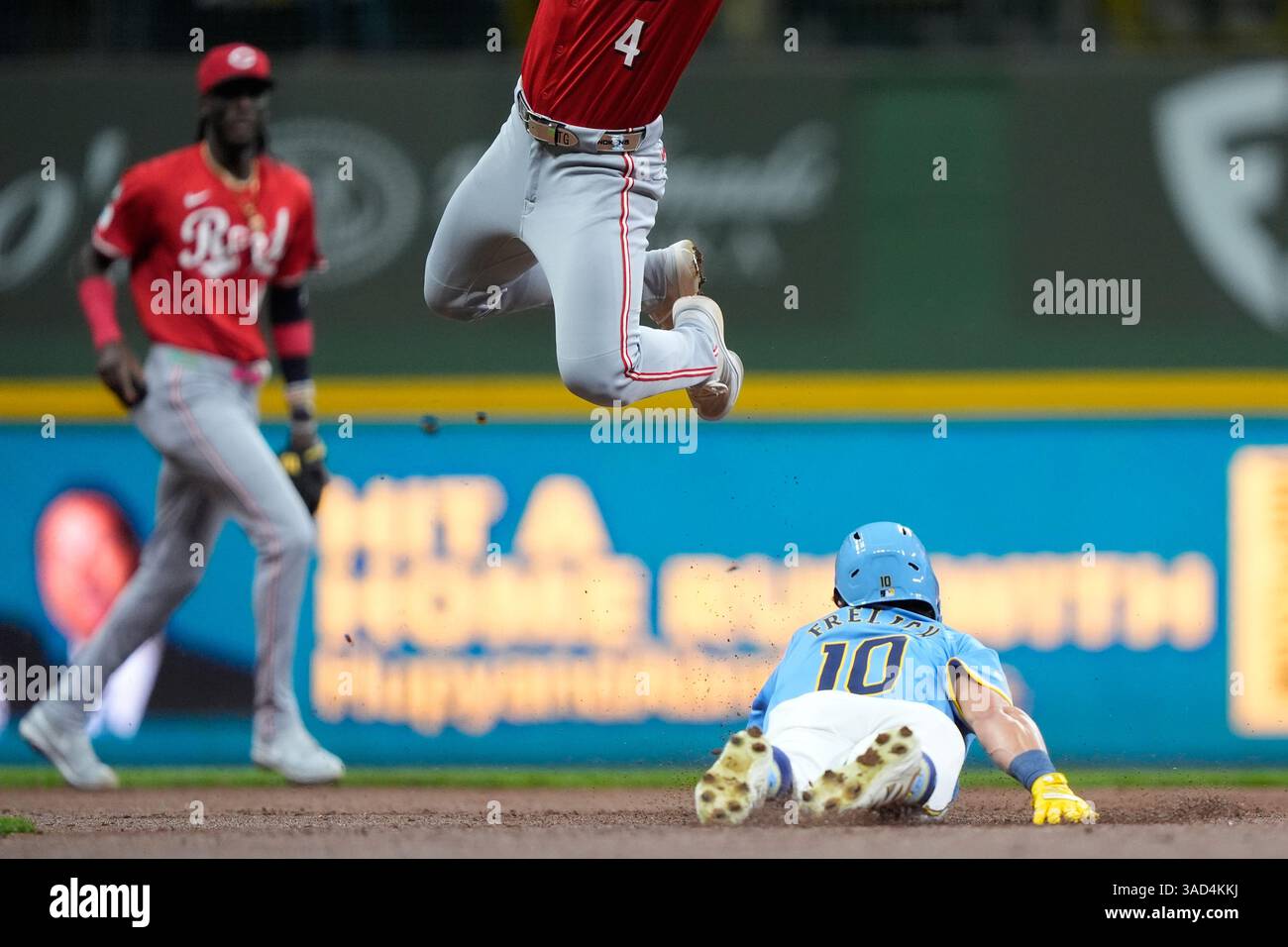 Milwaukee Brewers' Sal Frelick (10) steals second base past a leaping ...