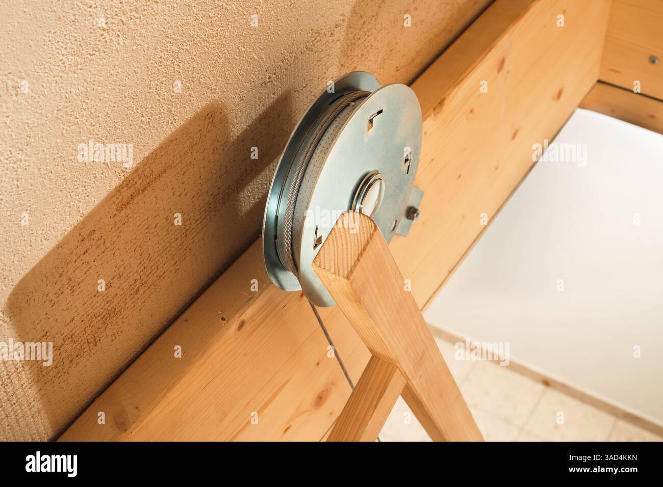 Pulley on loft ladder or attic ladder in staircase of building. Close ...