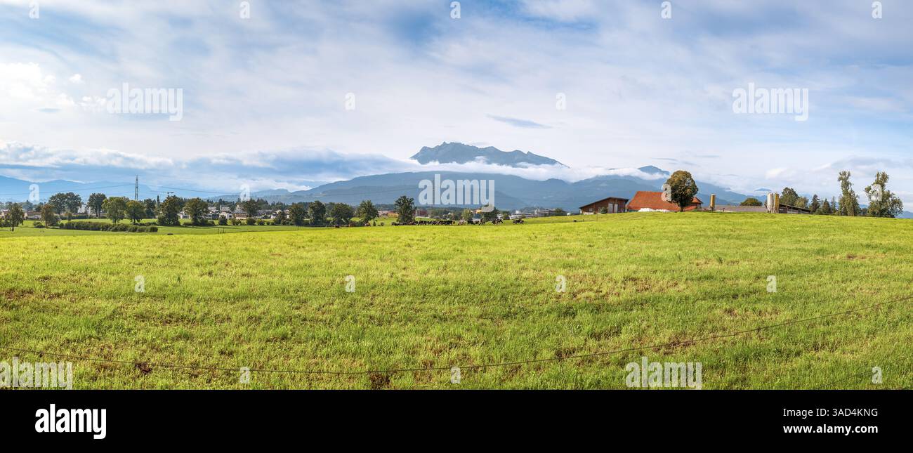 Rural swiss countryside with mountain peak and dramatic sky. Panorama ...