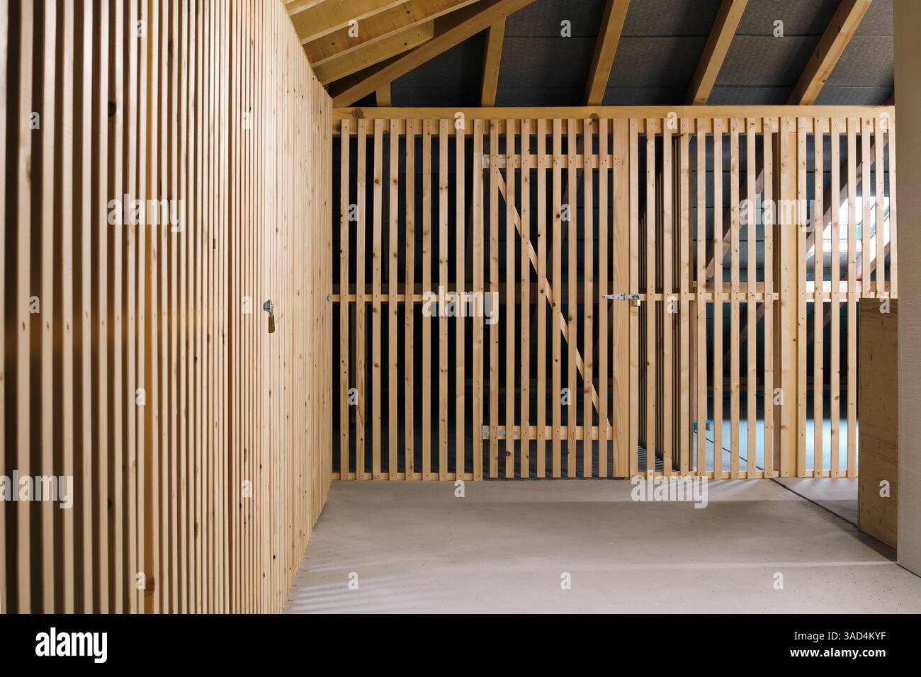 Attic storage in 4-story building. Multiple storage units with wood ...