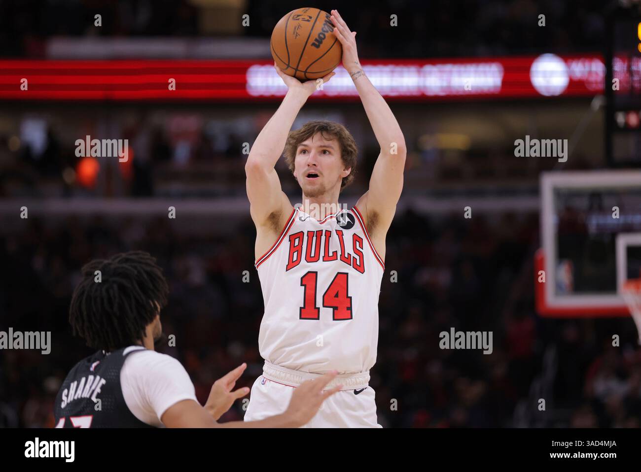 Chicago Bulls forward Matas Buzelis (14) shoots a three-point basket during the first half of an ...