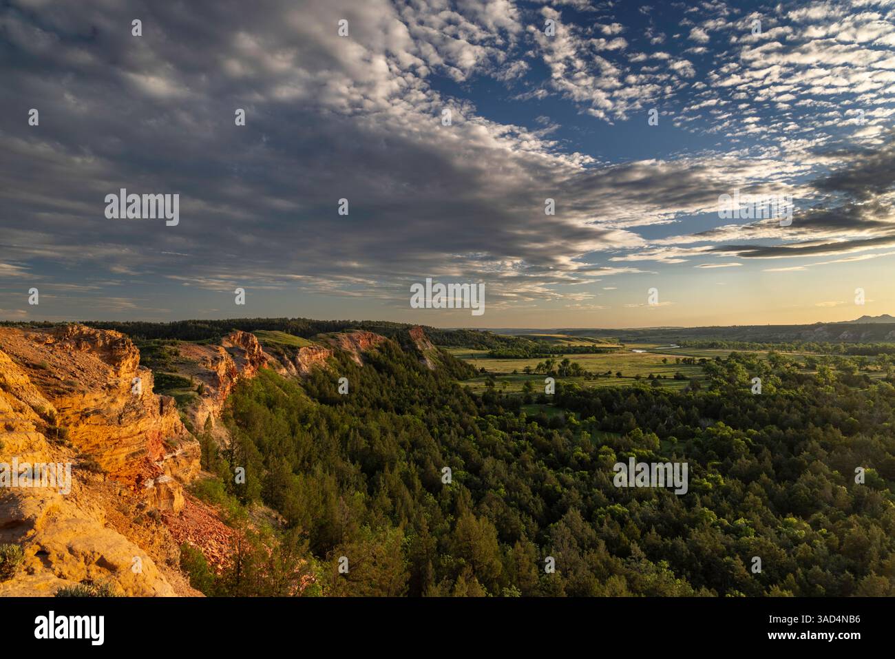 Days last light on the red cliffs of the Little Missouri River in the ...