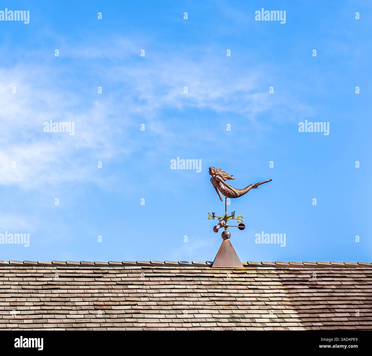 copper mermaid weather vane on top of a roof Stock Photo - Alamy