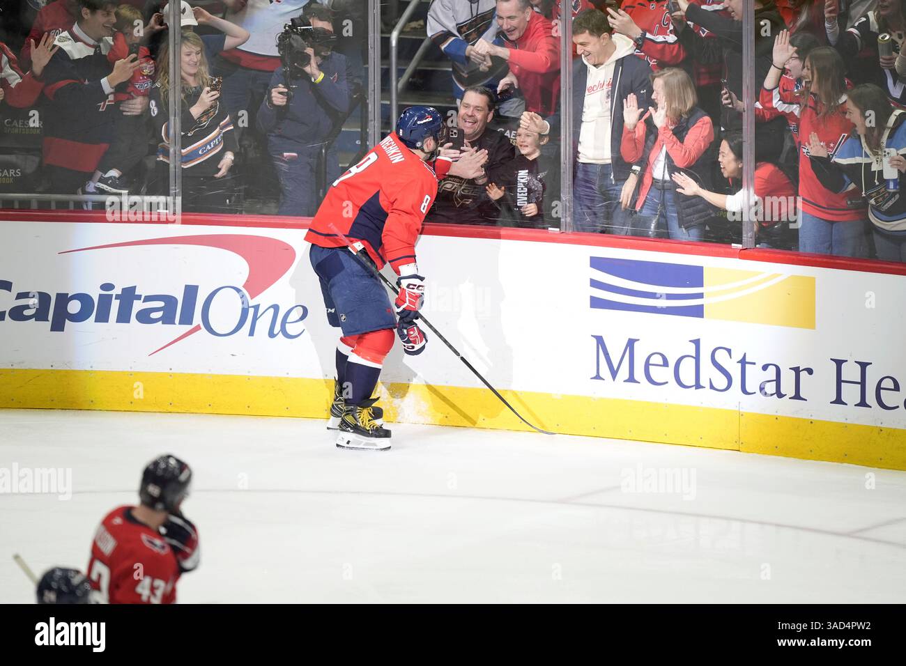 Washington Capitals left wing Alex Ovechkin (8) skates over to his son ...