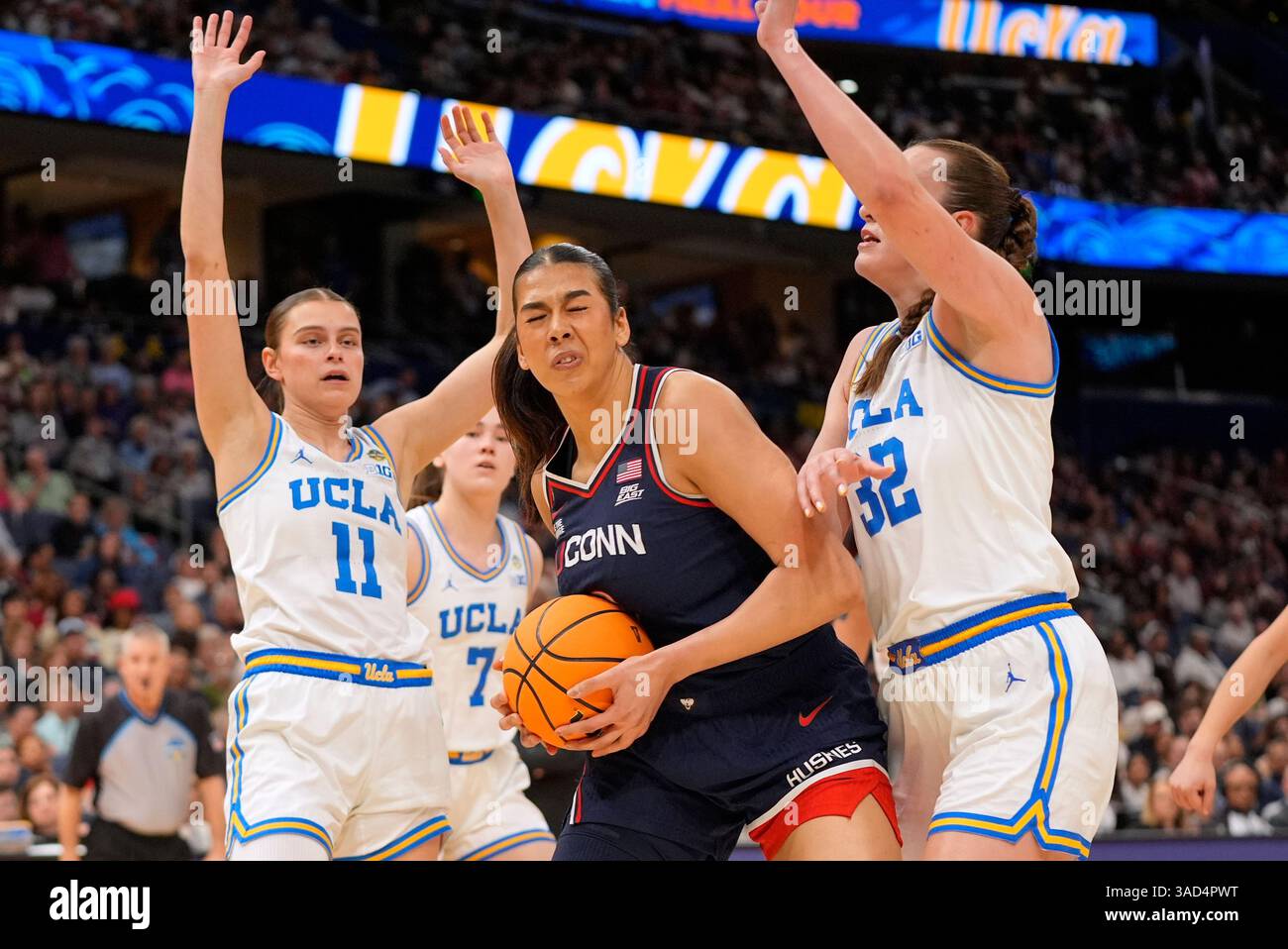 UConn center Jana El Alfy (8) grabs a rebound against UCLA guard Gabriela Jaquez (11) and ...