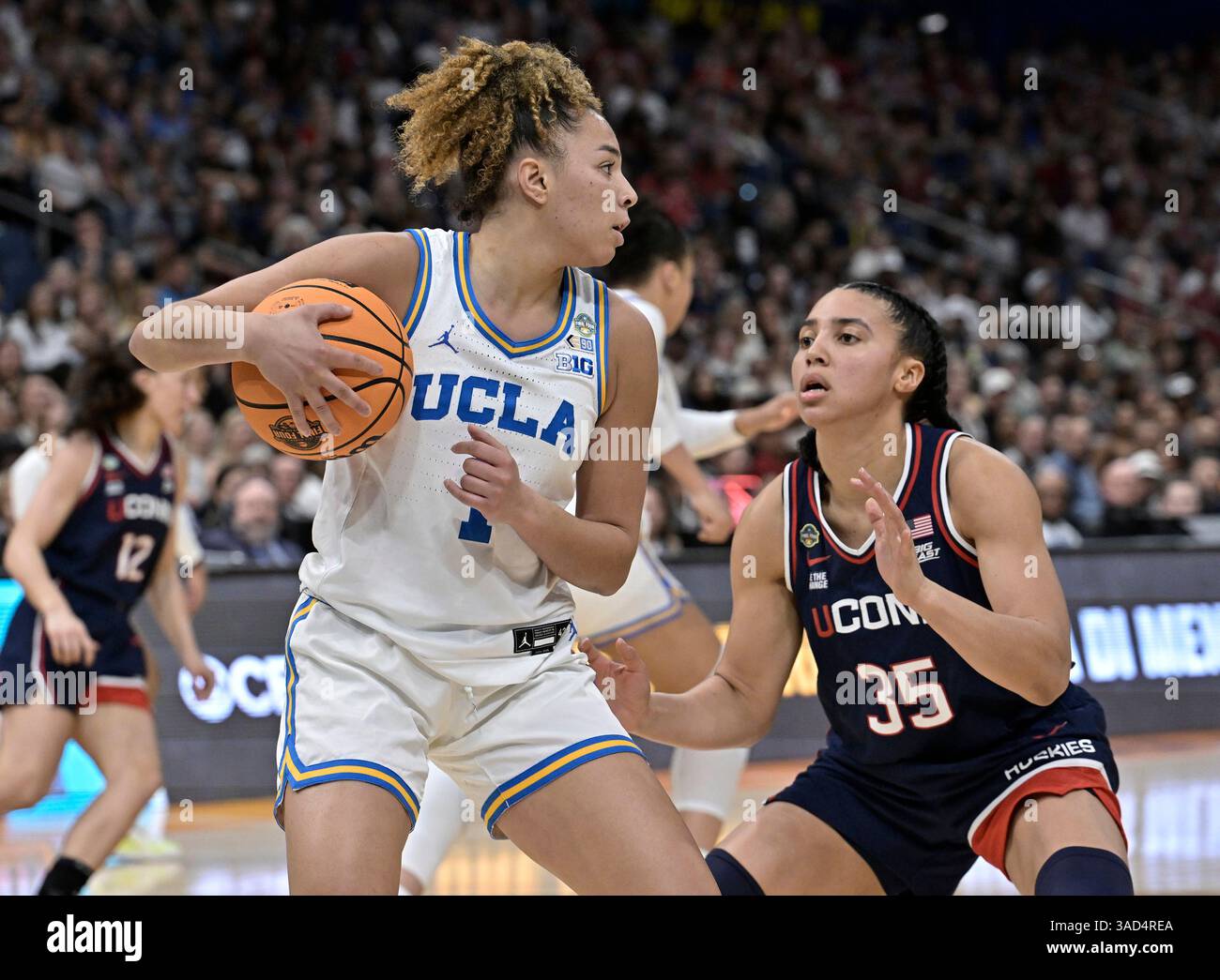 UCLA guard Kiki Rice (1) is guarded by UConn guard Azzi Fudd (35) in ...