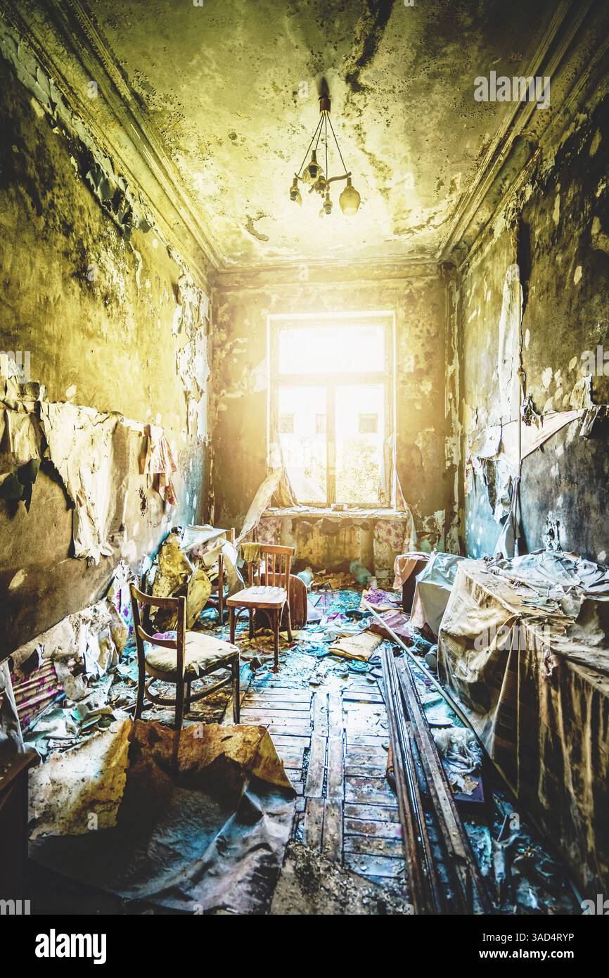 Abandoned destroyed room with broken furniture and peeling walls ...