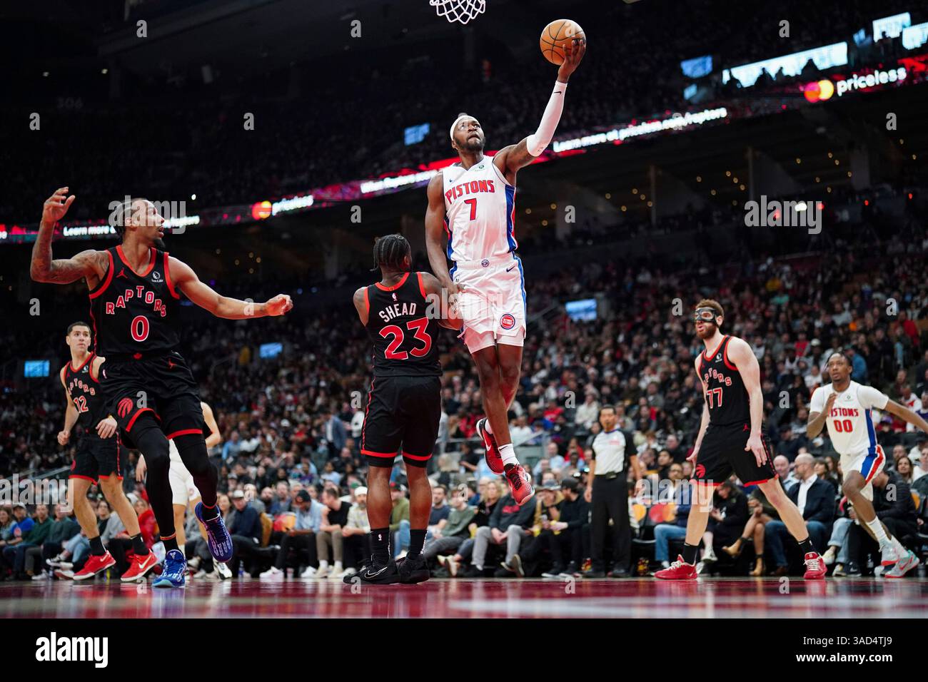 Detroit Pistons forward Paul Reed (7) goes up to score as Toronto Raptors guard Jamal Shead (23 ...