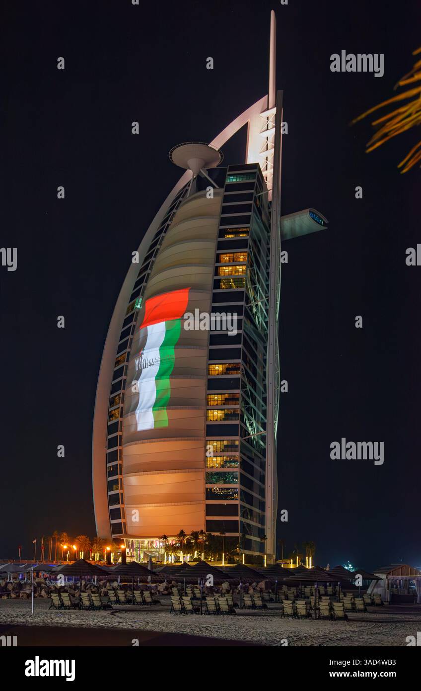 The Burj Al Arab fancy hotel modern architecture skyscraper at night ...