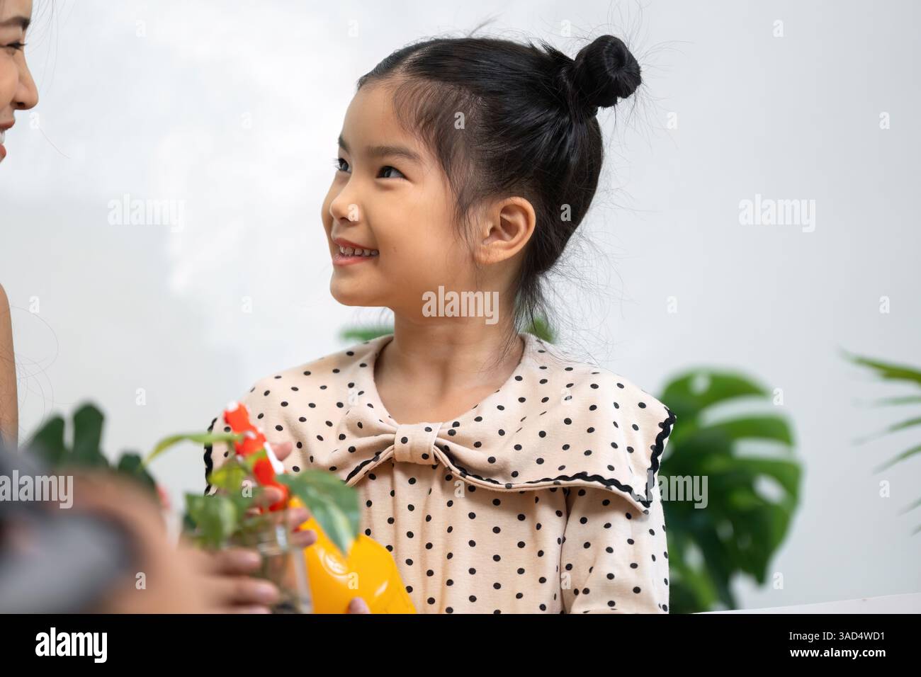 Connecting Through Nature. A girl smiles as she engages in a fun ...