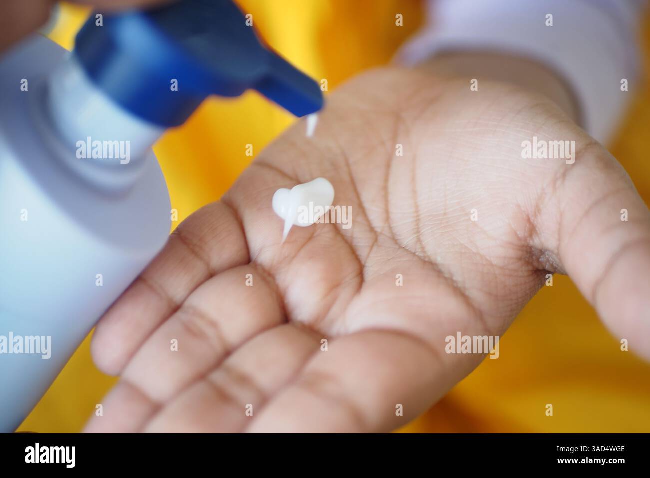 Applying lotion to child hand for hydration and skincare routine Stock ...