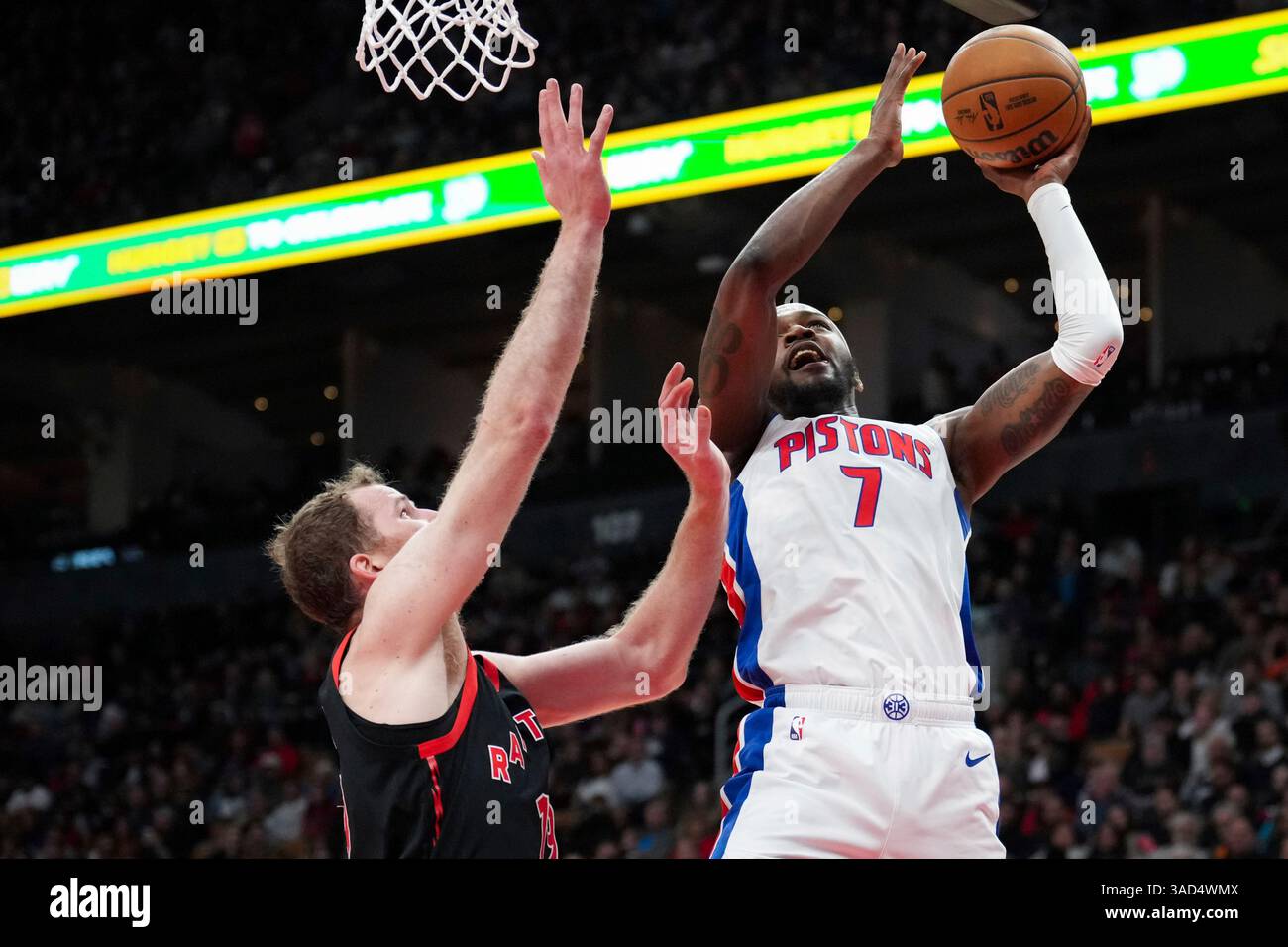 Detroit Pistons forward Paul Reed (7) shoots over Toronto Raptors center Jakob Poeltl (19 ...