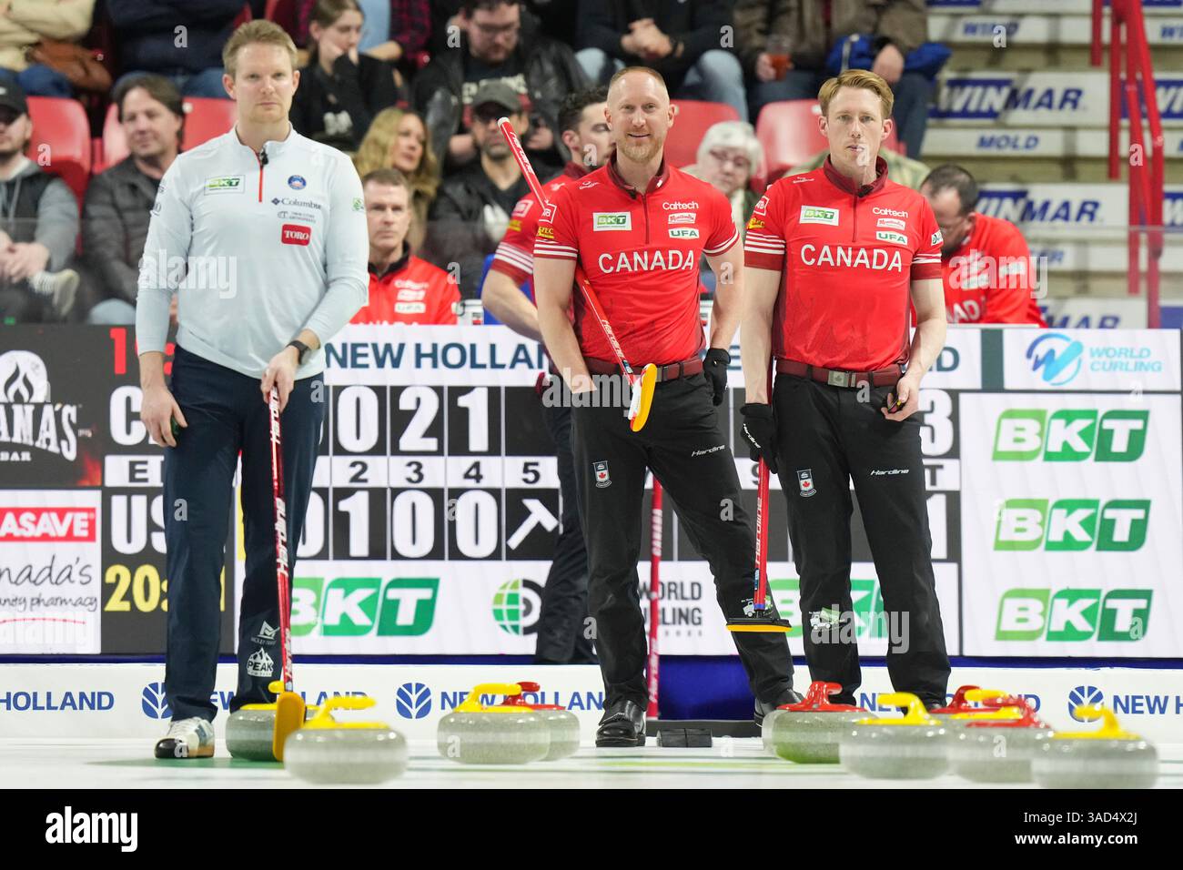 Canada skip Brad Jacobs, center, smiles as he stands with teammate Marc ...