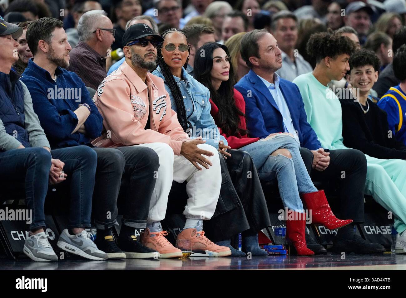 Swizz Beatz, third from left, and his wife Alicia Keys sit courtside ...