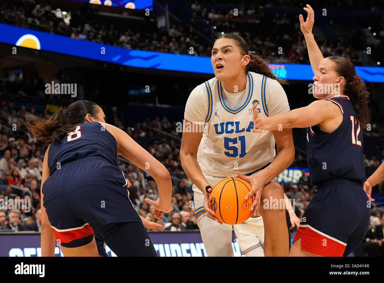 UCLA center Lauren Betts (51) goes up for a shot against UConn center Jana El Alfy (8) and guard ...